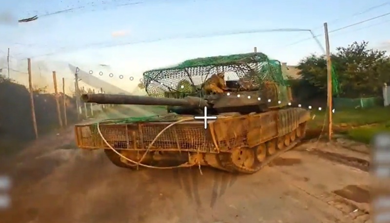 Drone Targets Tank with Crew Member Exposed on Turret