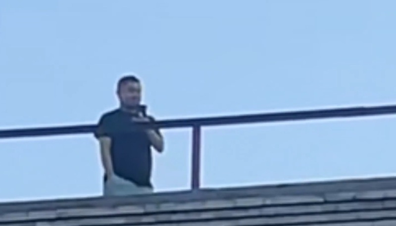 Protestor on Roof Catches Rubber Bullet with Chin